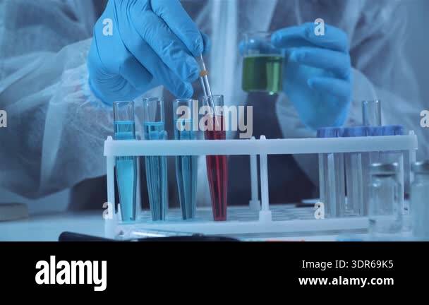 Professional chemist analyzing liquid samples in a research lab. Using ...