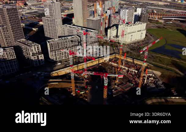 Aerial view of a large construction site with multiple tower cranes ...