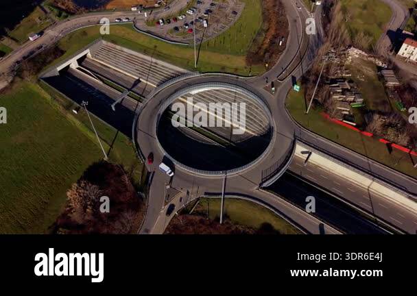 High angle aerial view of a unique circular road junction. Cars and ...
