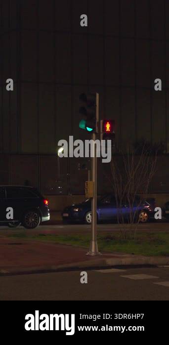 A traffic light is lit up green and a pedestrian crossing sign is lit ...
