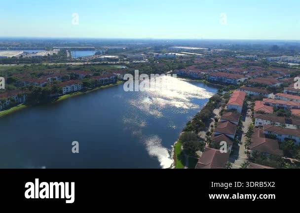 Aerial view of Miramar Florida lake fountains sun reflection and red ...