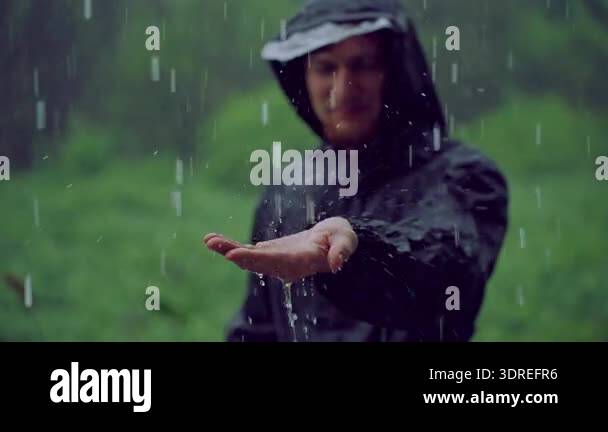 A Man Reaching Out His Hand Into Strong Tropical Rain As Water Splashes ...