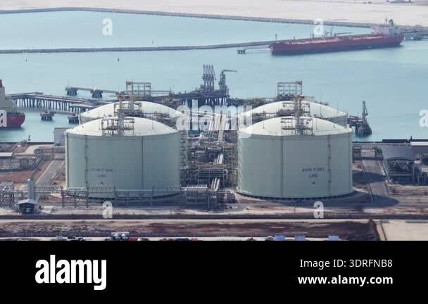 Aerial view of a large liquefied natural gas terminal featuring massive ...