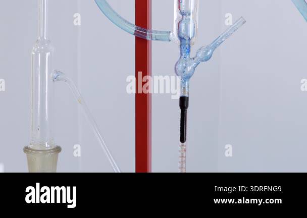 A close-up of glass lab apparatus connected by tubing, showcasing a ...