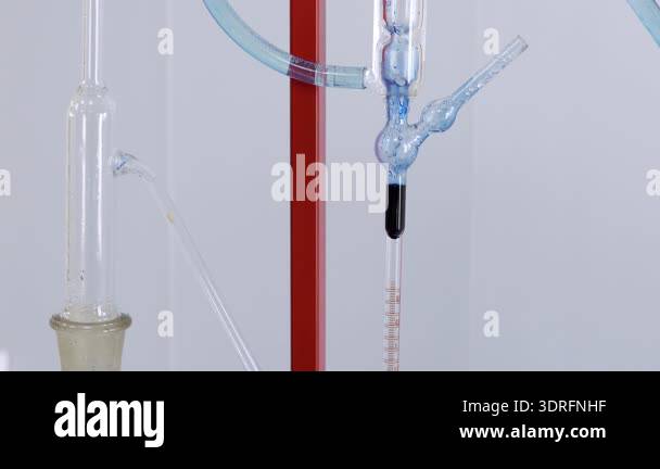 A close-up of glass lab apparatus connected by tubing, showcasing a ...