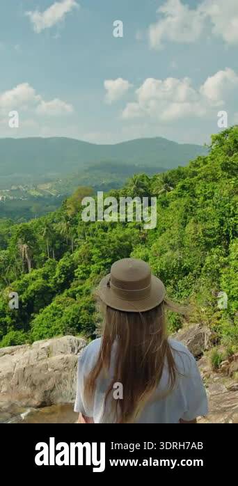Young woman in straw hat standing on cliff viewpoint above Na Muang 2 ...