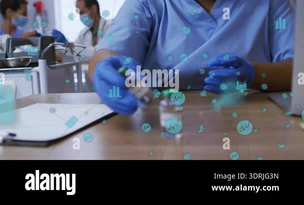 Nurse reaching and picking up vials for sample analysis on lab bench ...