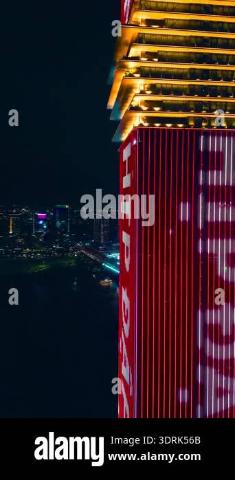 illuminated skyscraper with led screen advertisement, colourful ...