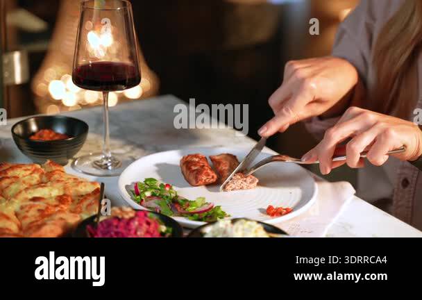 Elegant Woman eating Delicious food at Restaurant Using Knife and Fork ...