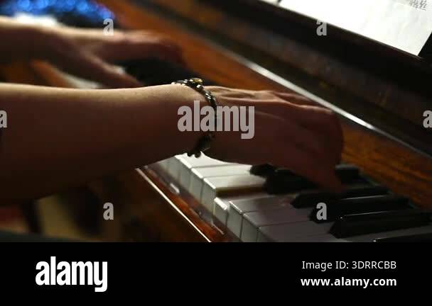 Hands playing piano keys. live music performance, closeup detail ...