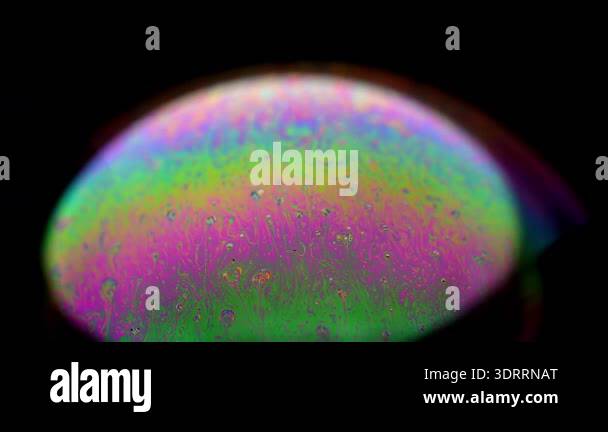 A mesmerizing seamless 4K macro loop of a giant soap bubble floating ...