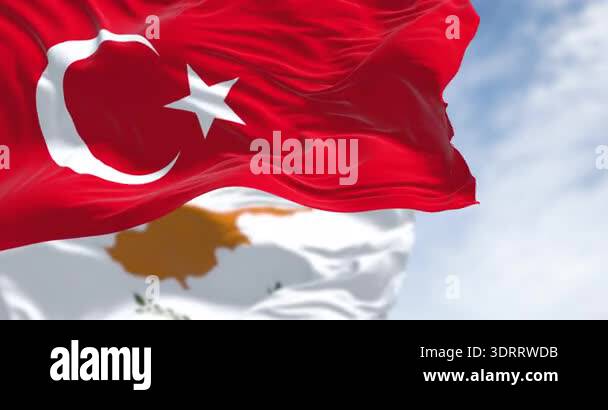Turkish and cypriot national flags waving in the wind on a clear day ...