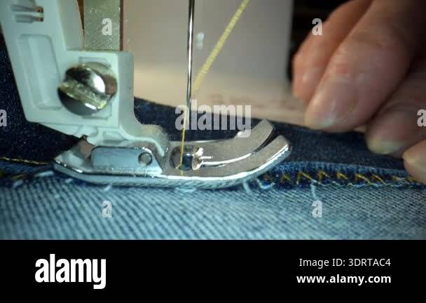 Close up view of sewing machine stitching zipper on fabric, garment ...