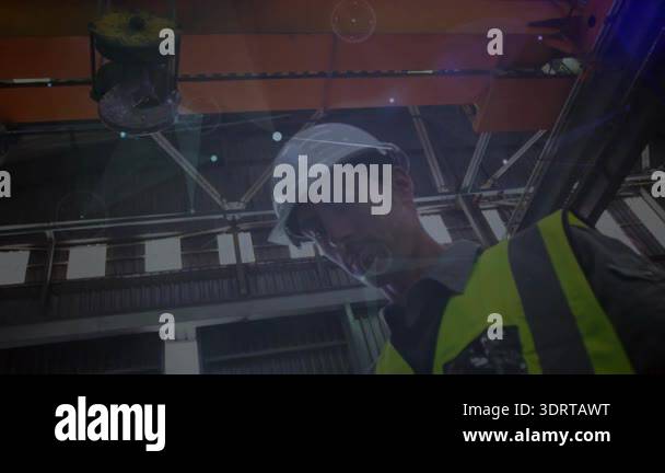 Engineer retrieving tablet under crane activating AR and projecting ...