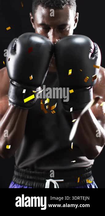 Animation of confetti falling over african american male boxer on black ...