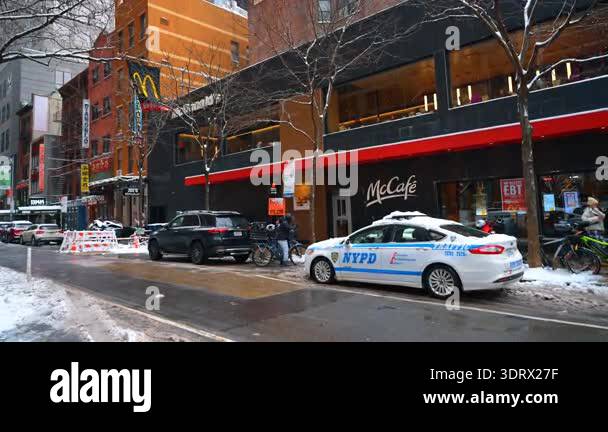New York, USA, 9 February 2026: NYPD traffic police car parked on snowy ...