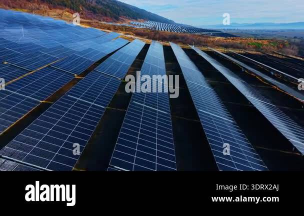 Industrial solar panel rows on hills. Close high angle perspective of ...