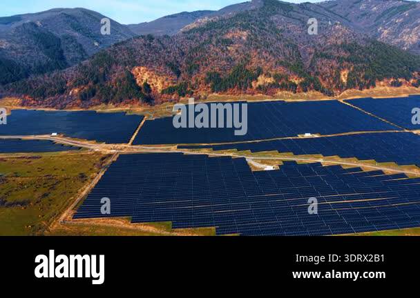 Photovoltaic solar panels installed on rural mountain slope. Rows of ...