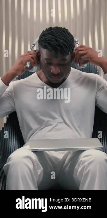 Concentrated African American man guy male put on headphones opening ...