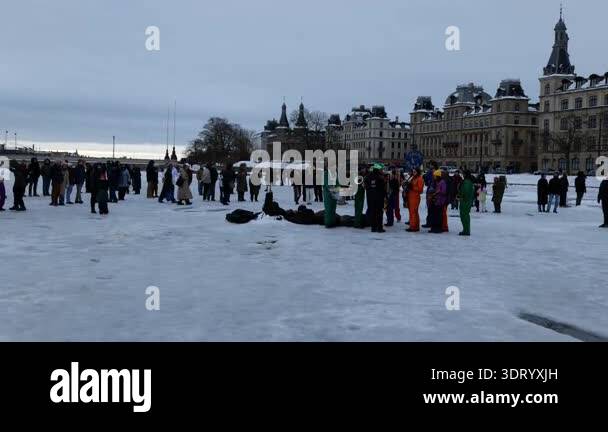 Musicians sing and play while standing on the ice in the middle of a ...