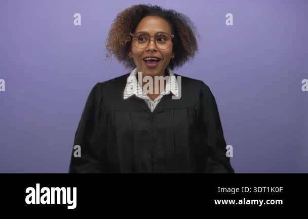 Woman judge in black robe with glasses, hands to head and open mouth in ...