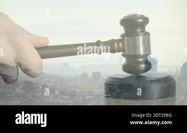 At start, hand holding gavel over city skyline, bringing gavel down on ...