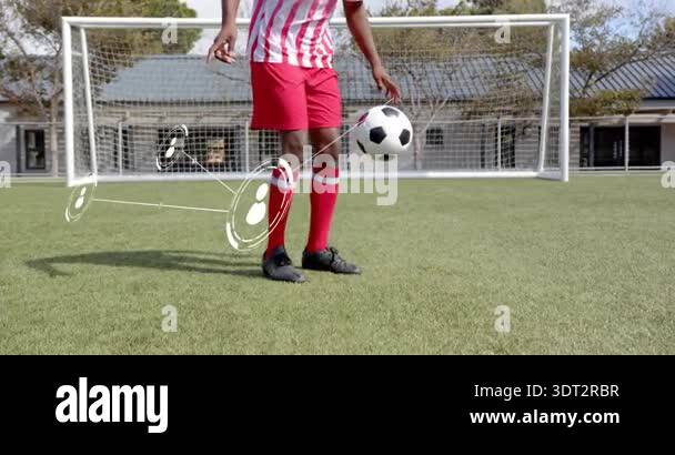 Soccer player tapping ball initiating juggling in training, showing ...