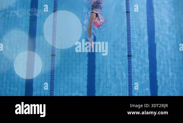 Female swimmer pushing off wall and gliding down lane for sports ...