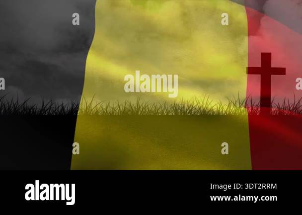 Breeze waving black-yellow-red flag, rippling stripes over grass and ...