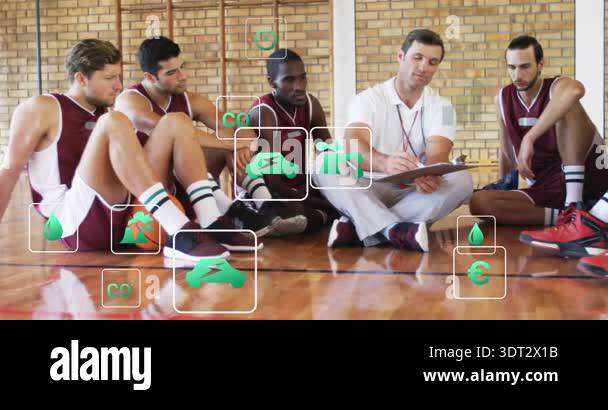 Basketball coach drawing play diagrams on clipboard and guiding seated ...