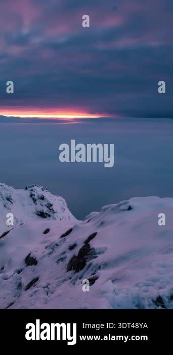 Vertical timelapse of the sun shining through a small gap in grey ...