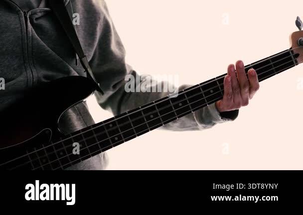 Strumming electric bass guitar. Musician plays music. Man fingers ...