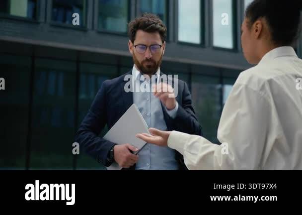 Angry African businesswoman female CEO boss irritated scold Caucasian ...