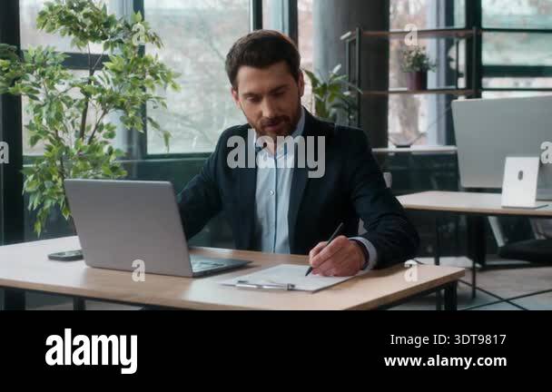 Busy successful Caucasian businessman working on laptop in office male ...