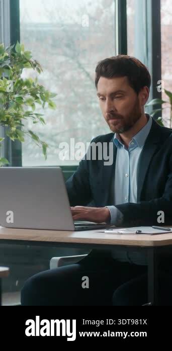 Caucasian businessman typing laptop in office writing notes ...