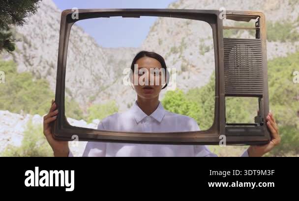 Retro TV frame talking head shot of woman outdoors in mountains ...
