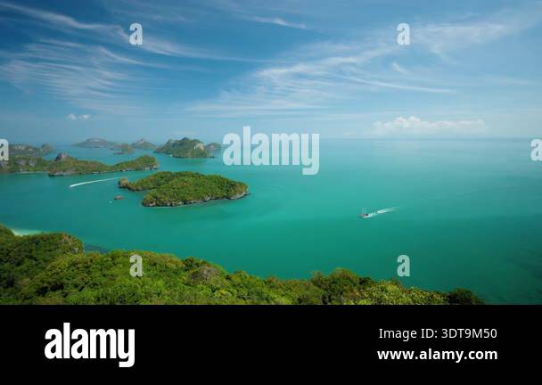 Aerial panoramic view of turquoise sea and lush limestone islands in ...