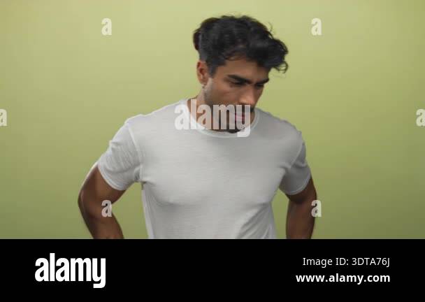 Man crosses arms in studio forming an x gesture with focused expression ...