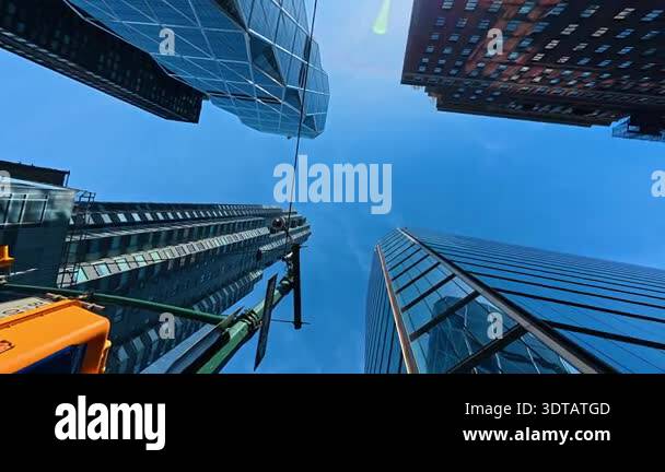 View on the tops of the glass skyscrapers from the ground. Circling ...