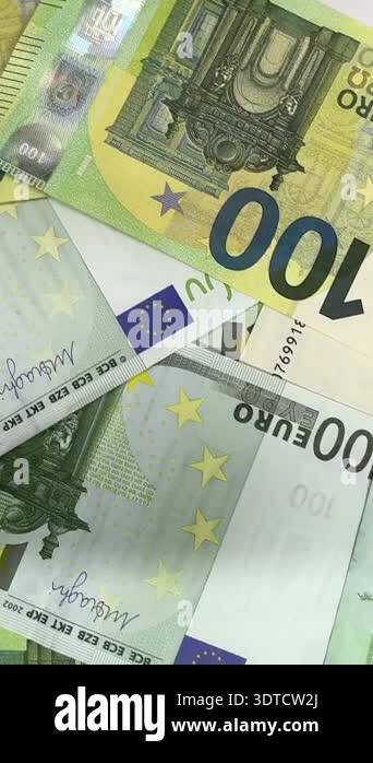 Close views of Euro banknotes are shown with details of each bill. The ...