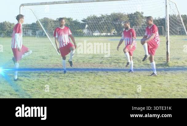 After gathering, four soccer players doing leg hugs then arm swings for ...