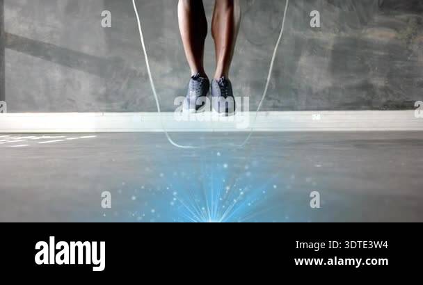 Man swinging jump rope and shifting weight hopping rhythmically with ...