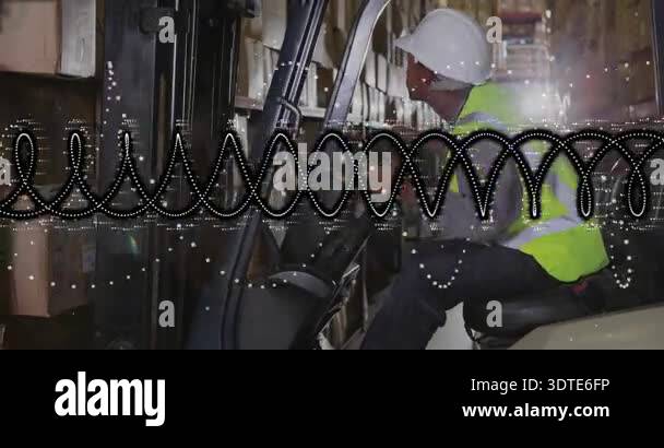 Forklift operator pushing lever under pallet for lift in depot with ...