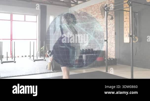 Lone woman entering gym with bag and bottle, lifting kettlebell ...
