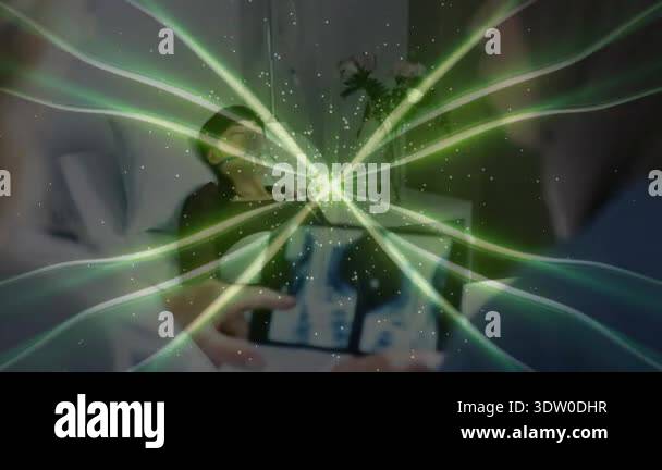 Clinician tapping tablet screen and animating green scan beams while ...