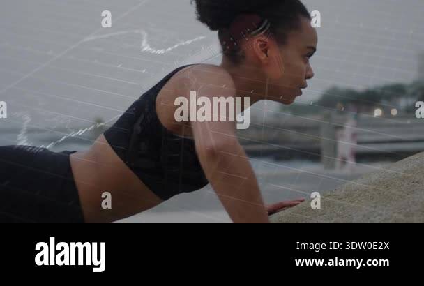 woman arriving on pier ledge and doing push-ups while tracking fitness ...