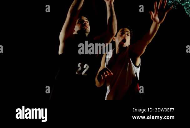 Basketball player lifting ball and shooting inducing green cloud around ...
