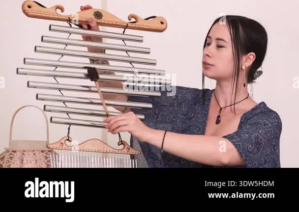Sound chimes. Yoga instrument. Woman playing crystal singing bowls ...