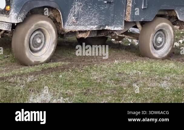 pickup truck with wheels spinning in the mud Stock Video Footage - Alamy