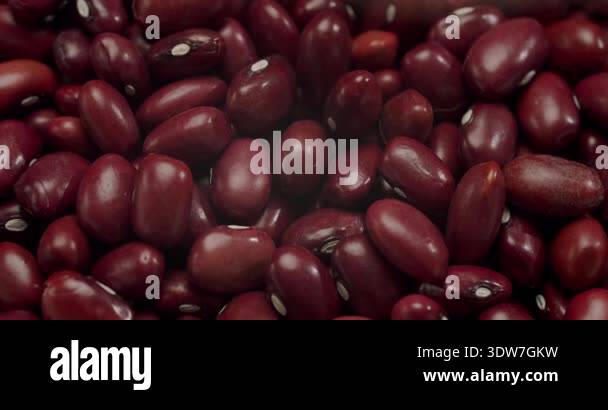 Detailed macro shot of raw red kidney beans rotating in slow motion ...